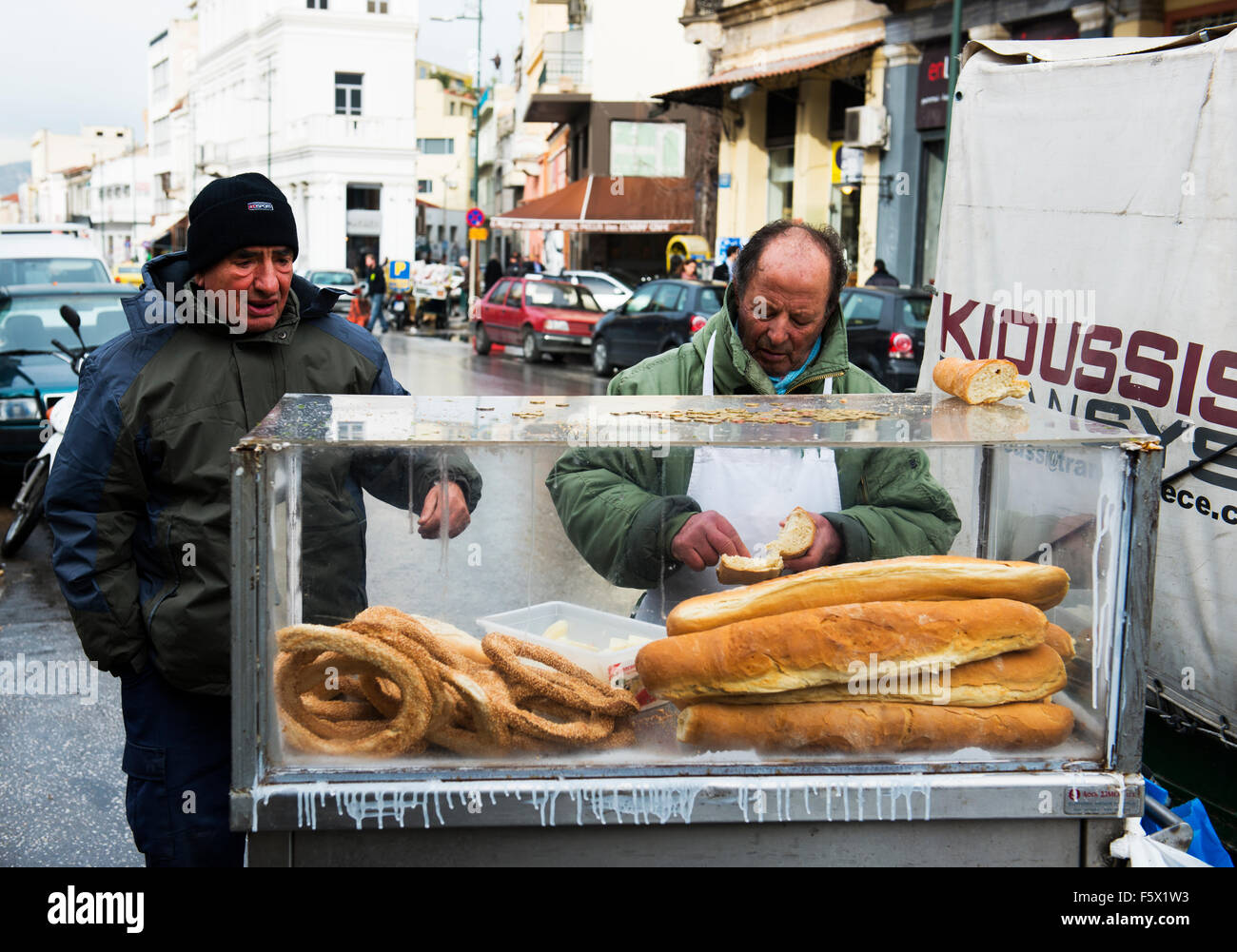 A Greek vendor selling koulouria - Greek style bagels and bread ...