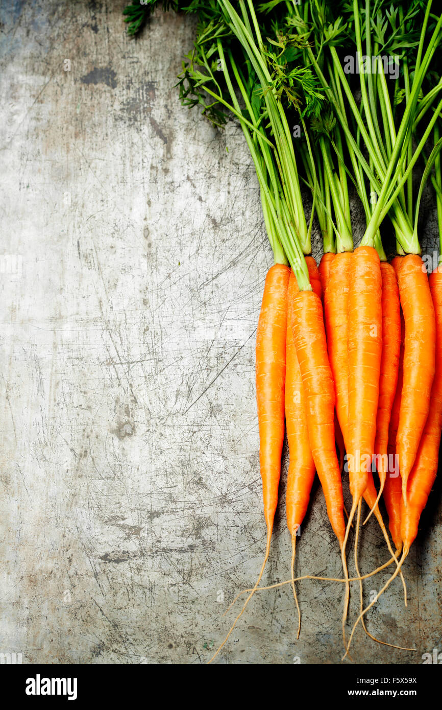 Carrots on old metal background Stock Photo - Alamy