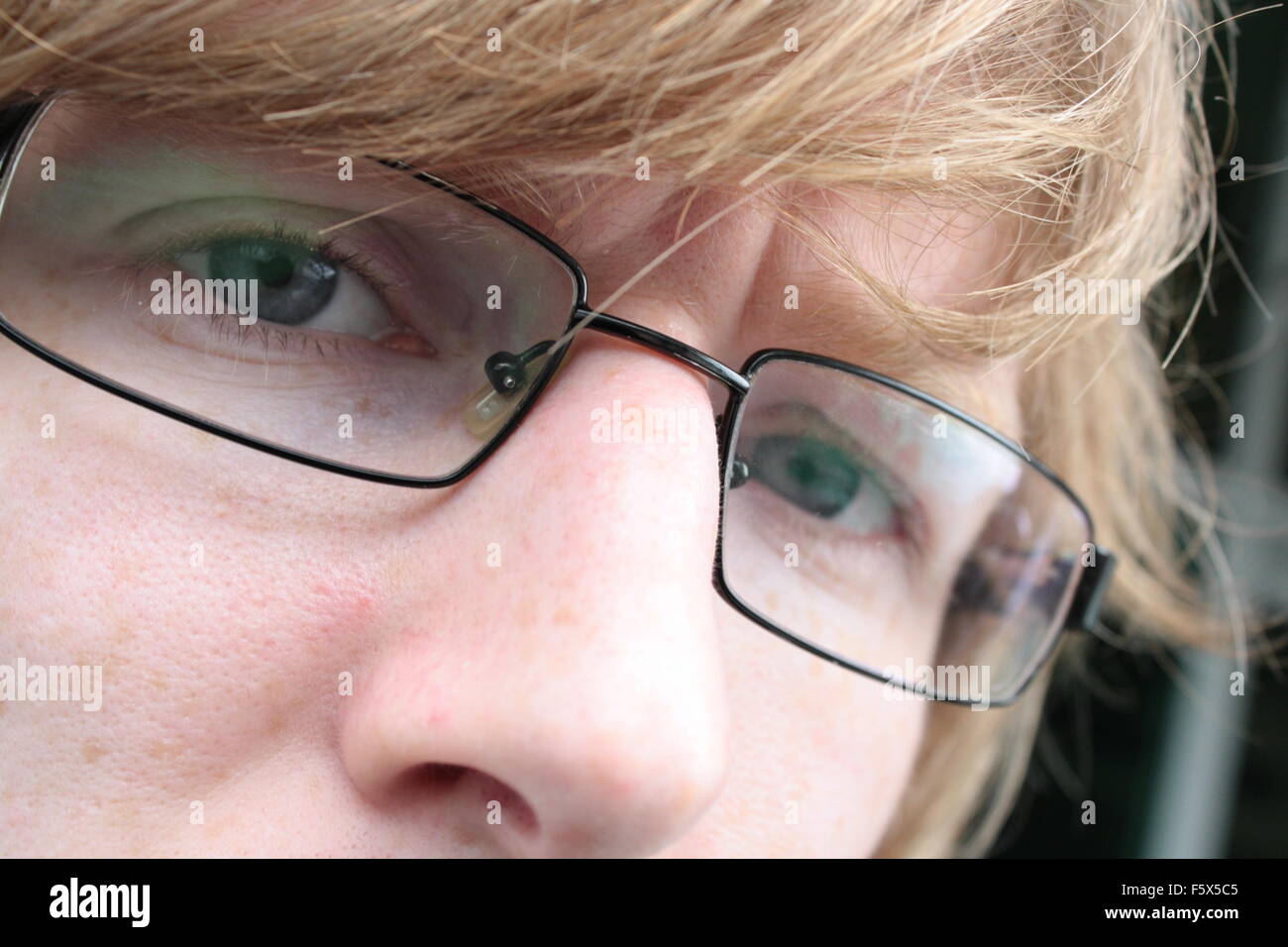 Frustrated / concerned / tired eyes close up of a young man with ...