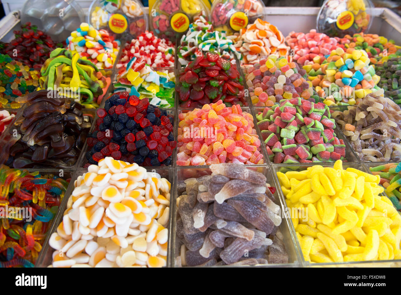 A colorful candy stall at the vibrant Machane Yehuda market in ...