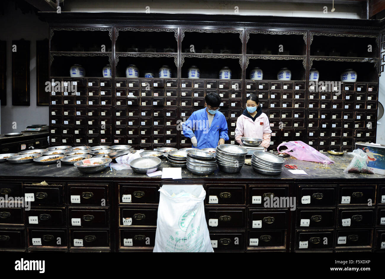 Pharmacist preparing herbal prescription at traditional Chinese ...
