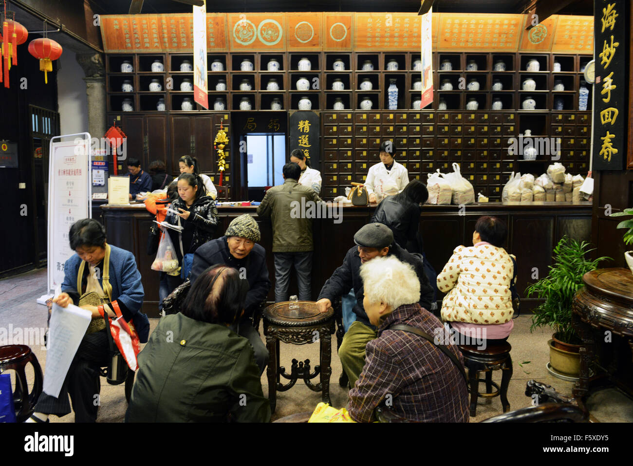 Pharmacist preparing herbal prescription at traditional Chinese ...