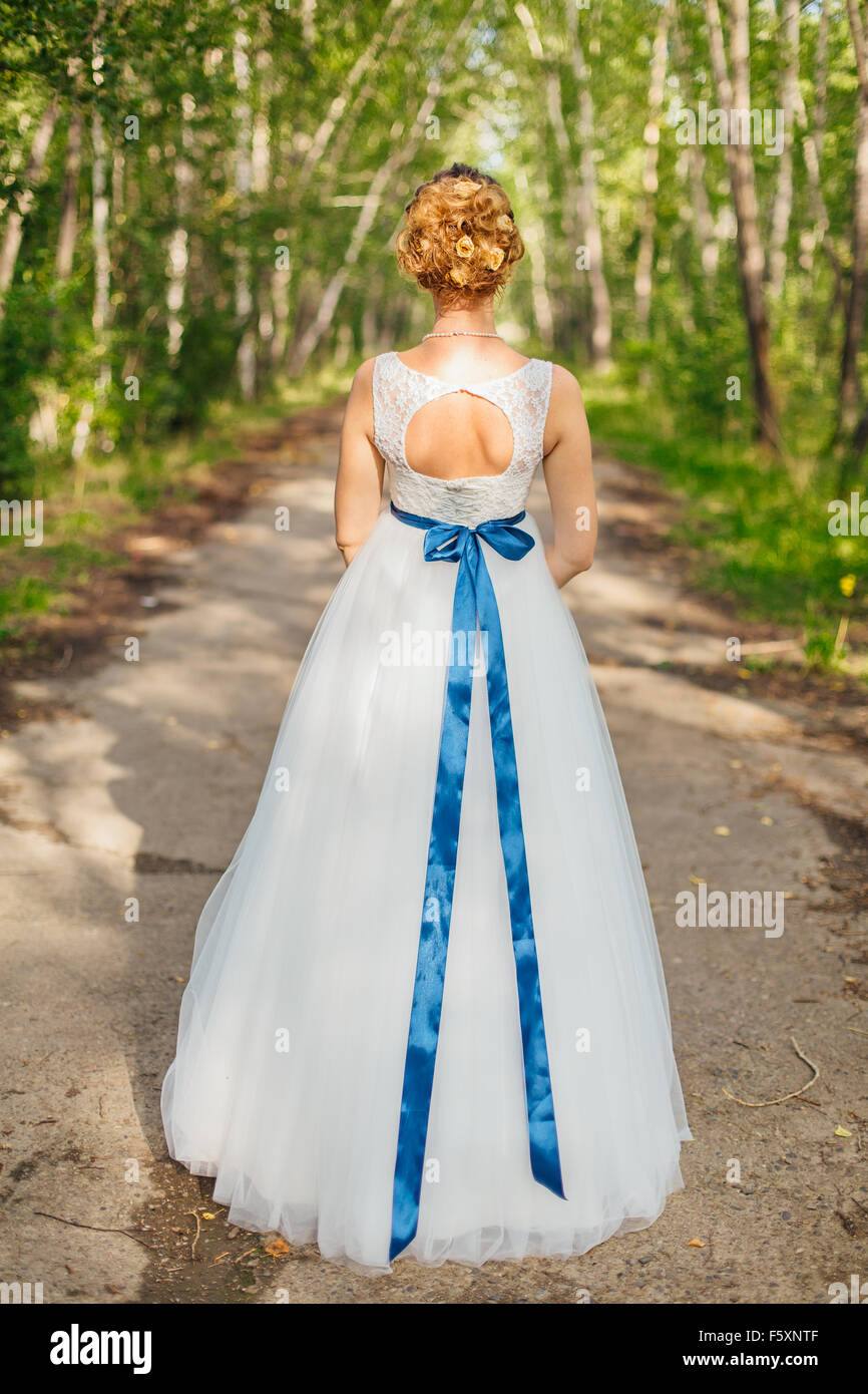Back of the bride with blue ribbon Stock Photo - Alamy