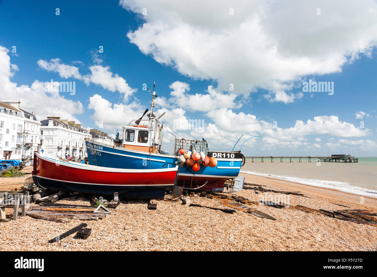 Kent coastal resort, Deal. View along shingle beach with two fishing ...