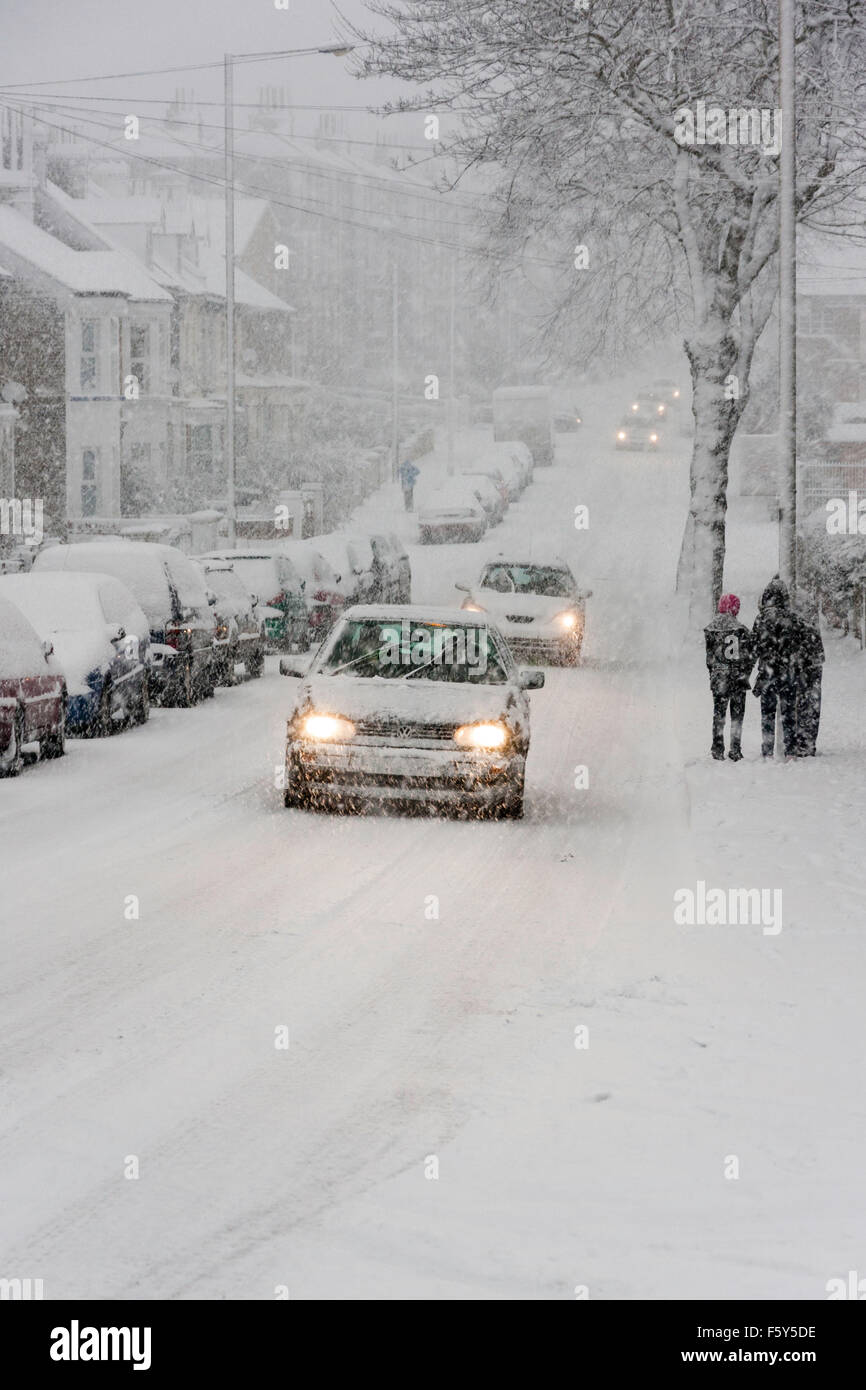 English street in Ramsgate. Heavy snow storm with snow falling and cars ...