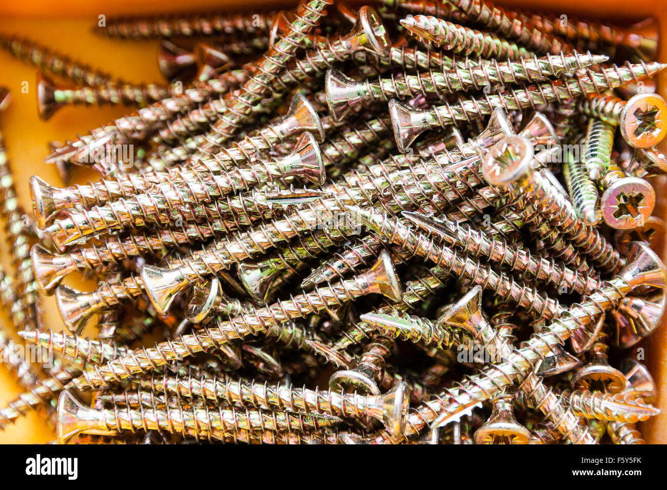 Gold coloured timber screws in yellow box compartment Stock Photo - Alamy