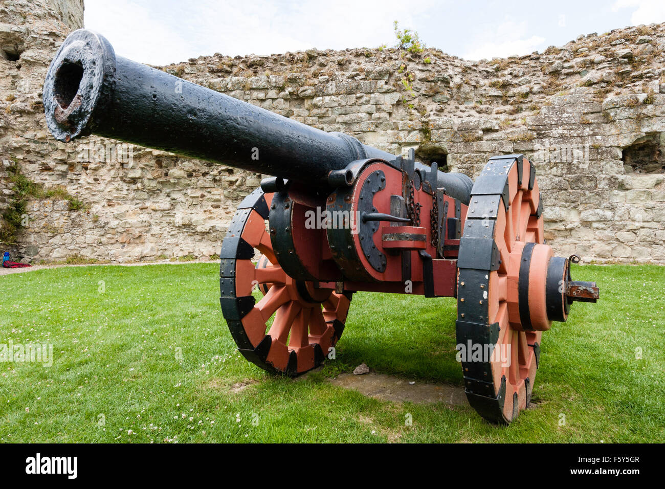 England, Pevensey castle. Elizabethan cannon, painted red and black ...