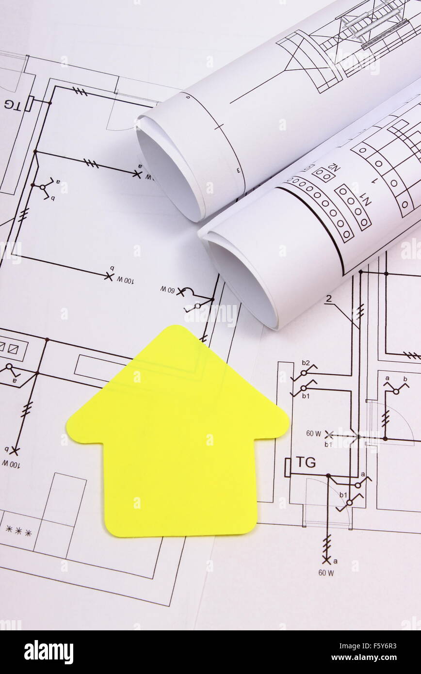 House of yellow paper and rolls of diagrams lying on electrical ...