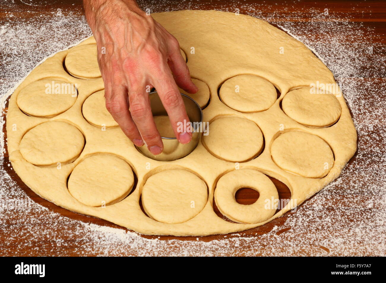 Cut Dough into ring. Making Doughnuts Stock Photo - Alamy
