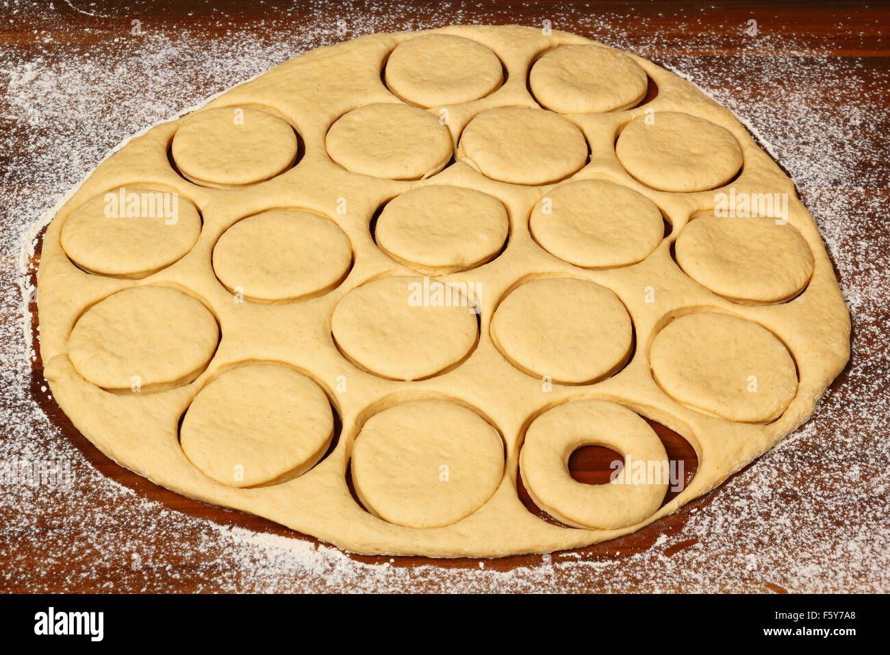 Cut Dough into ring. Making Doughnuts Stock Photo - Alamy