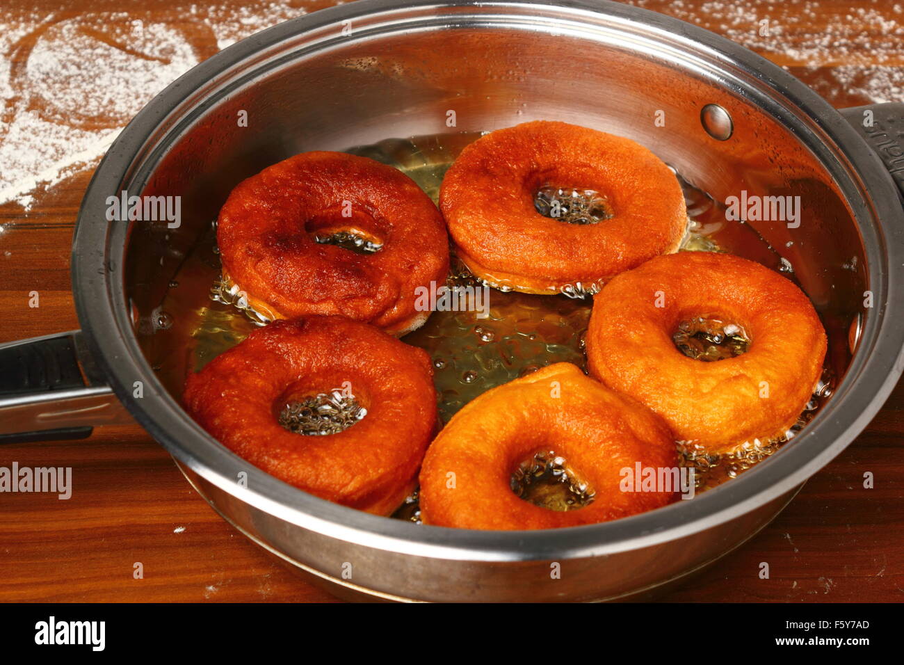 Frying Donut. Making Doughnuts Stock Photo - Alamy