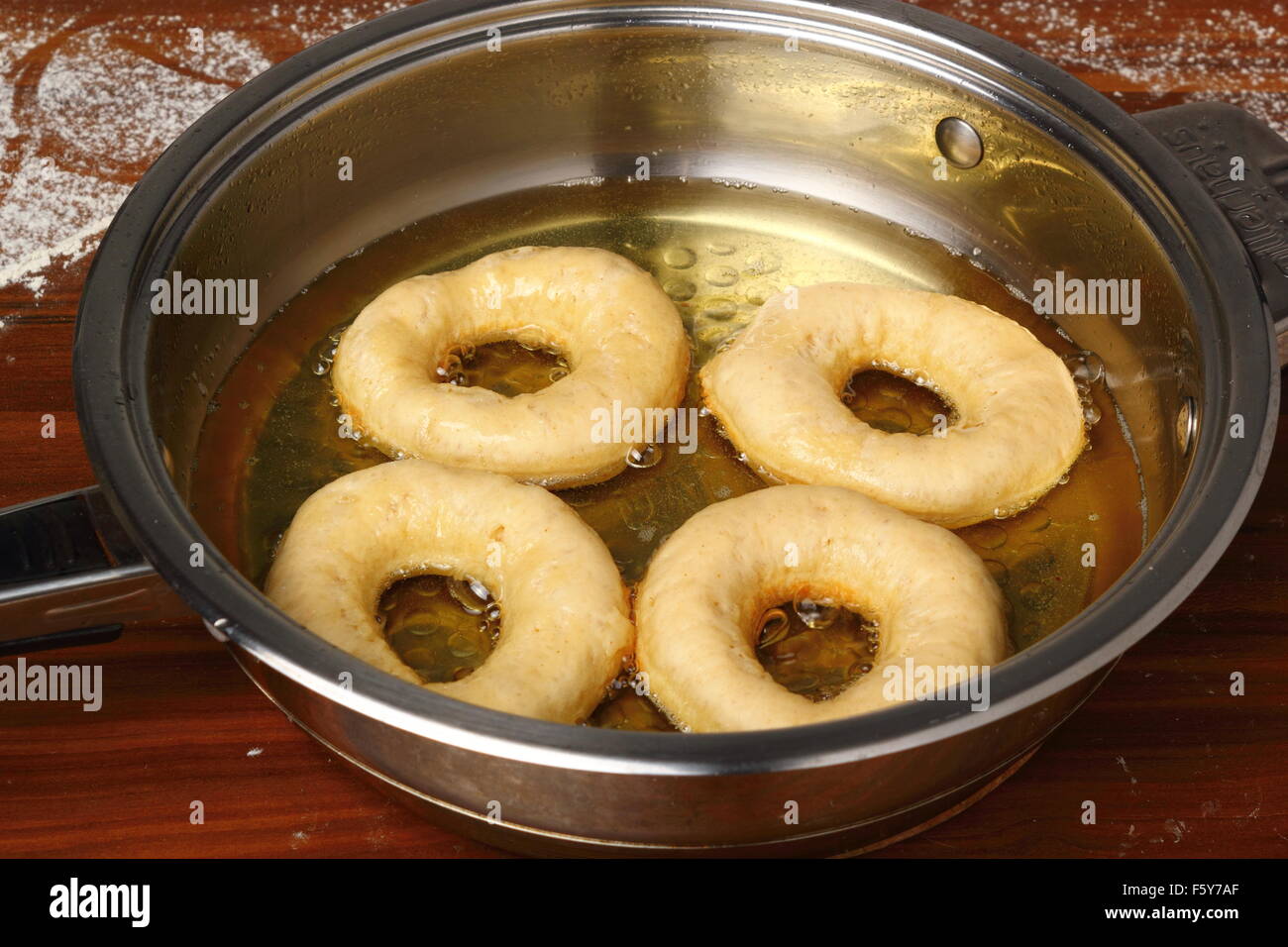 Frying Donut. Making Doughnuts Stock Photo - Alamy