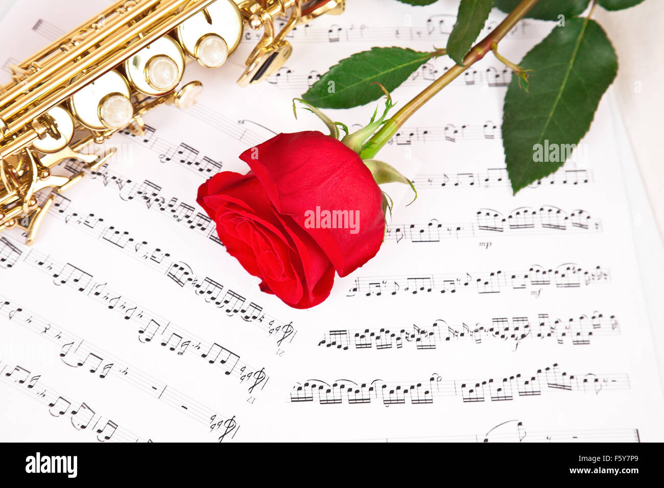 Musical notes and saxophone with red rose Stock Photo - Alamy