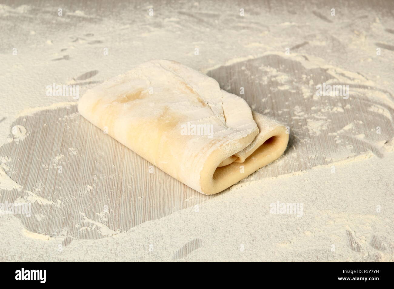 Making Puff Pastry. Folding lower third of dough over centre third and ...