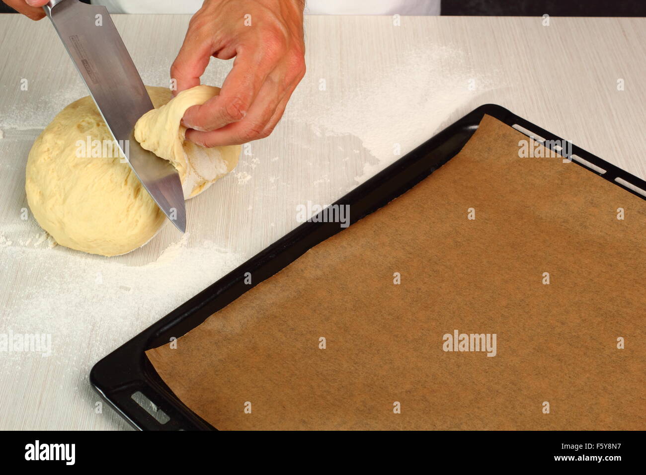 Cutting dough and forming buns. Making Yeast Sweet Roll Bun Stock Photo ...