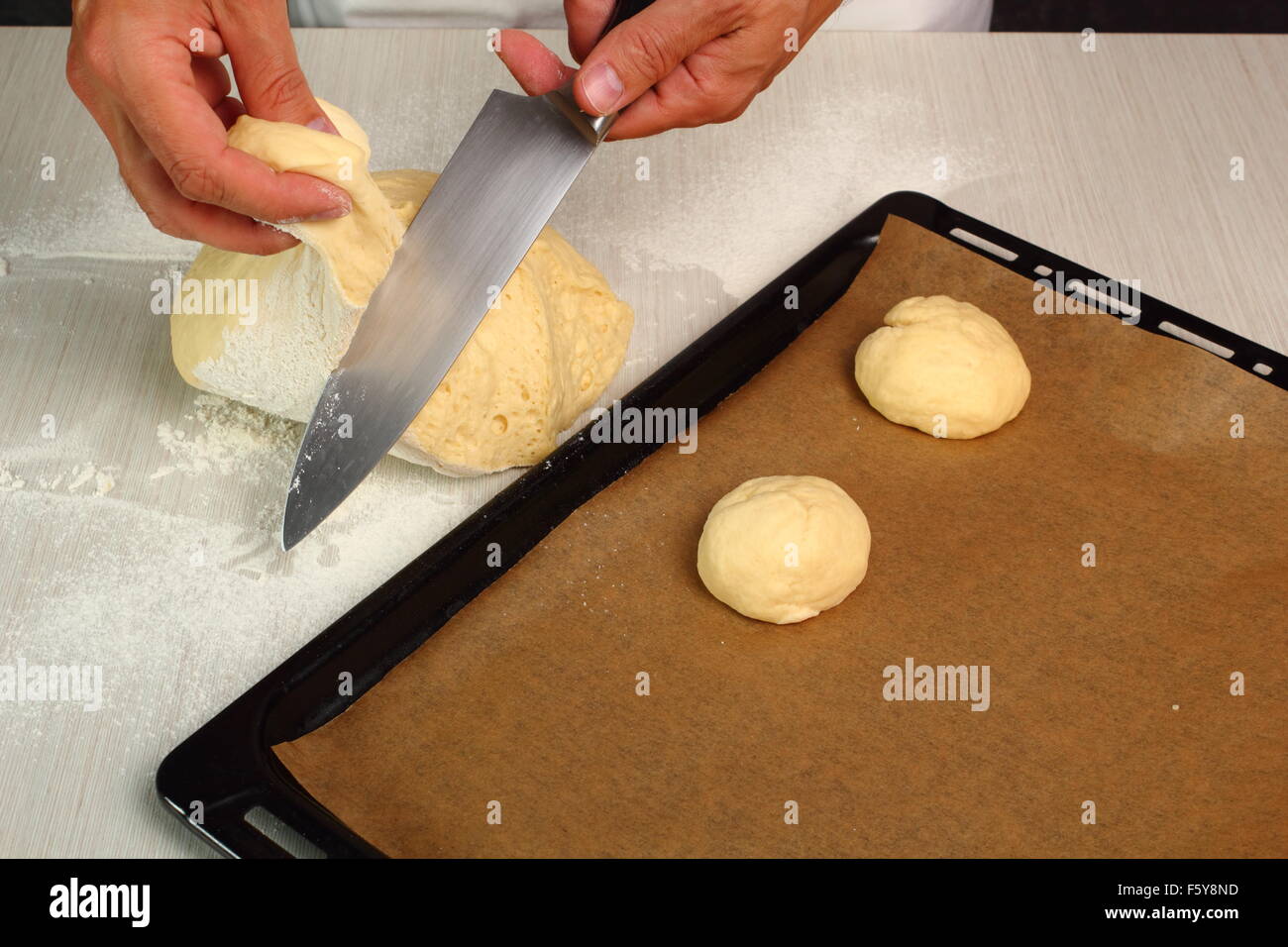 Cutting dough and forming buns. Making Yeast Sweet Roll Bun Stock Photo ...