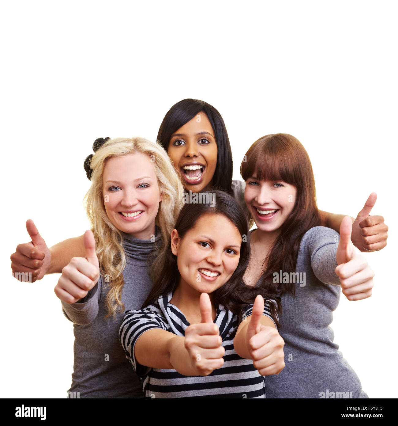 Four happy young women holding their thumbs up Stock Photo - Alamy
