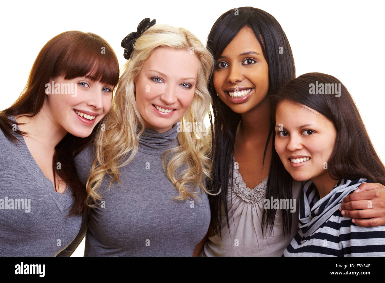 Four young happy smiling women grouped together Stock Photo - Alamy