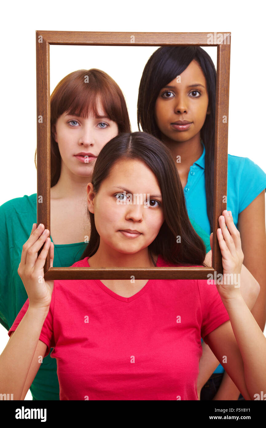 Three young beautiful women looking through an empty frame Stock Photo ...
