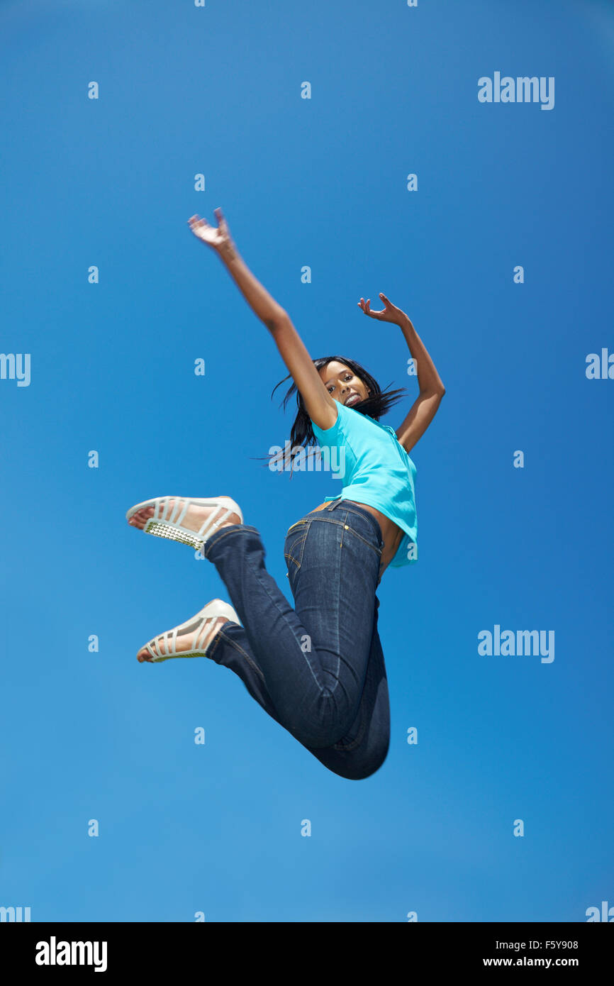 Young african woman jumping into the air Stock Photo - Alamy