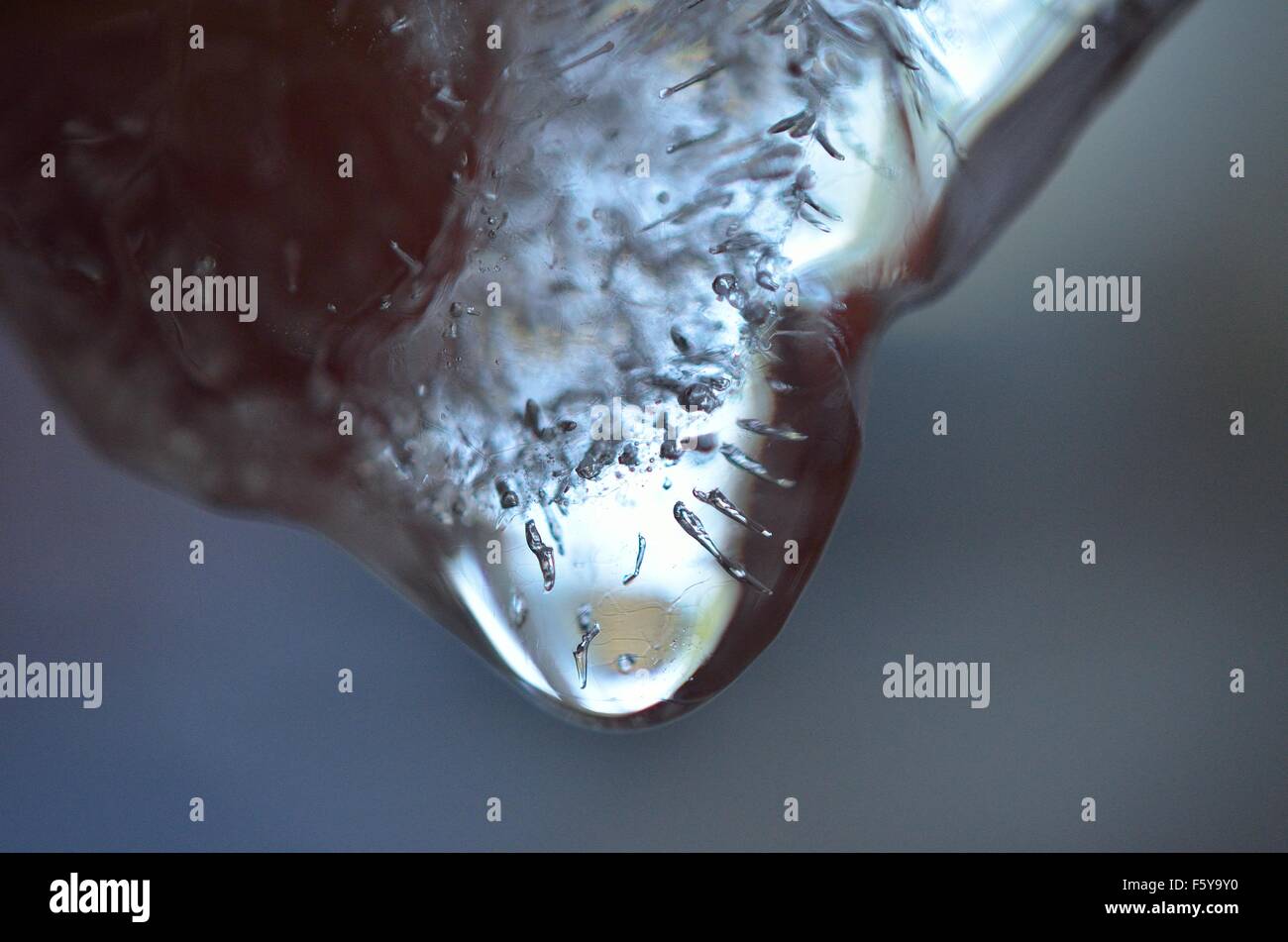 melting ice cube with hanging water drop Stock Photo - Alamy