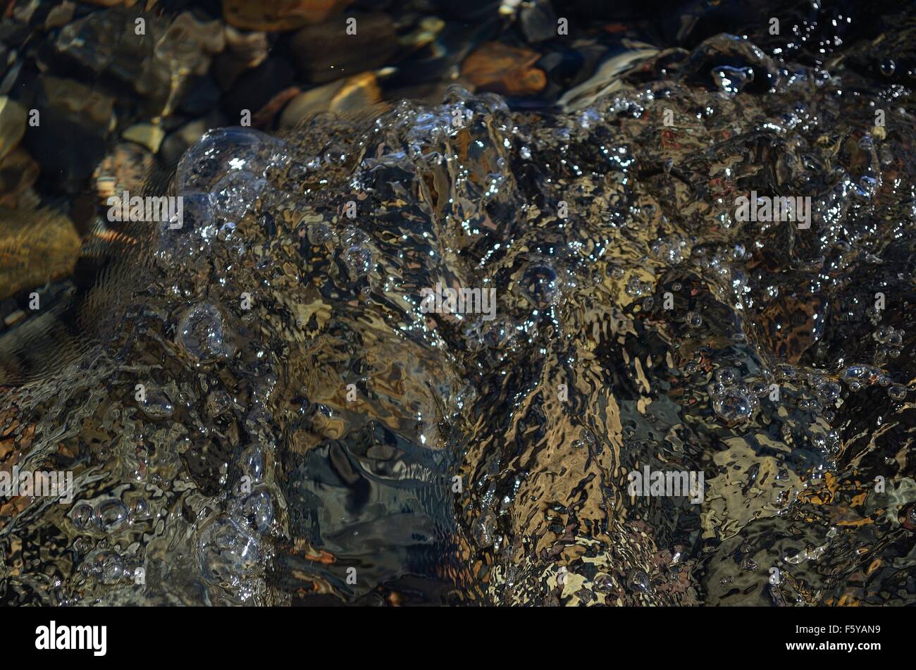 bubbly clean river water flow in summer sunshine macro photo Stock ...