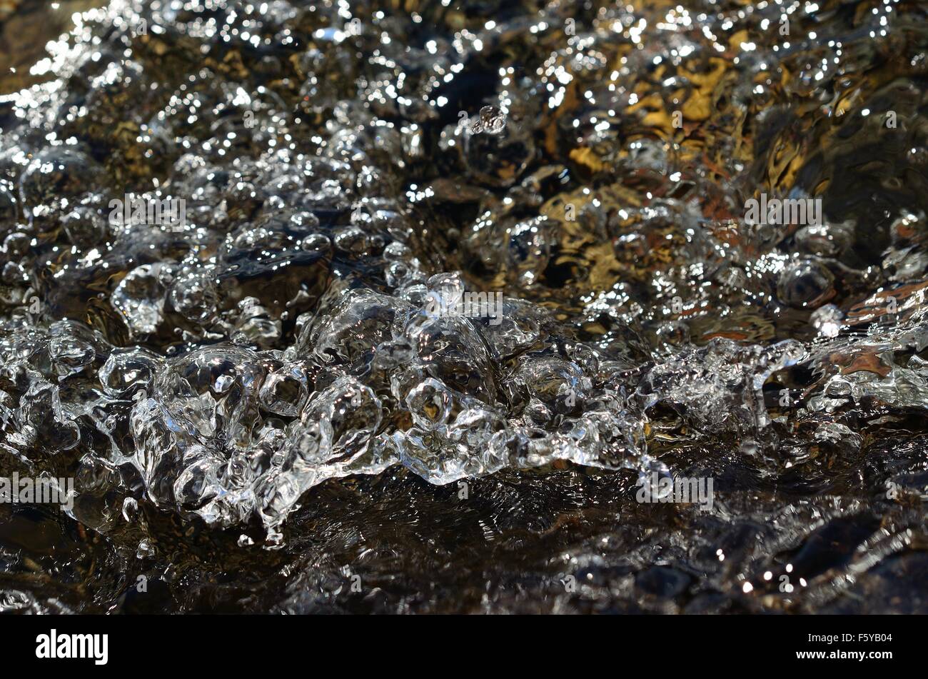 bubbly fresh river water flow macro photo background Stock Photo - Alamy