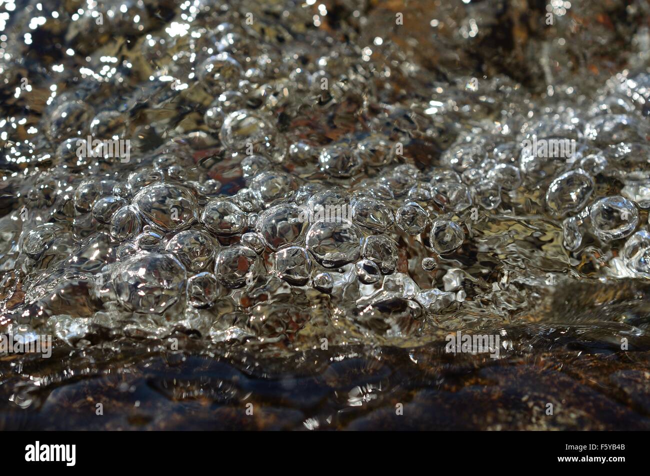 bubbly fresh river water flow macro photo background Stock Photo - Alamy