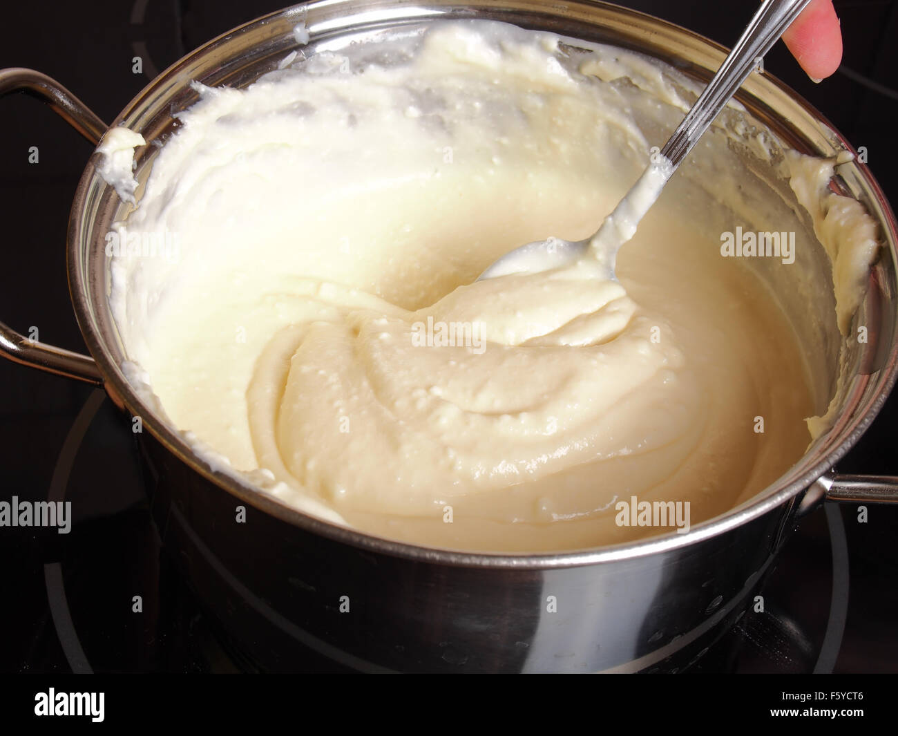 Heating cheese filling and mixing. Making Chocolate Layer Cake with ...