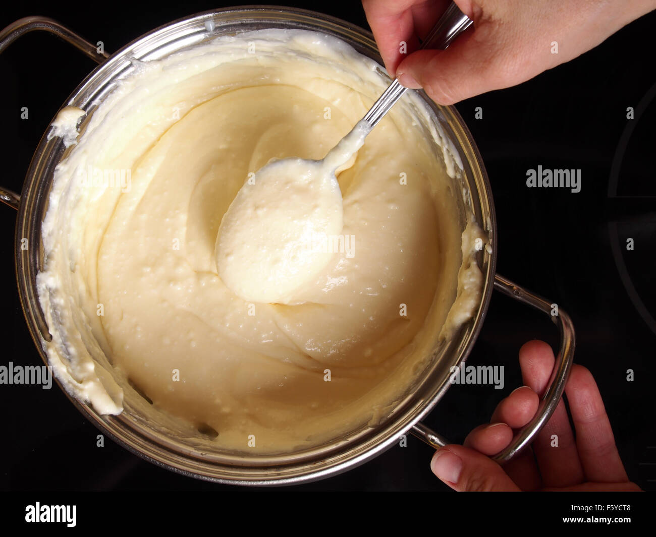 Heating cheese filling and mixing. Making Chocolate Layer Cake with ...