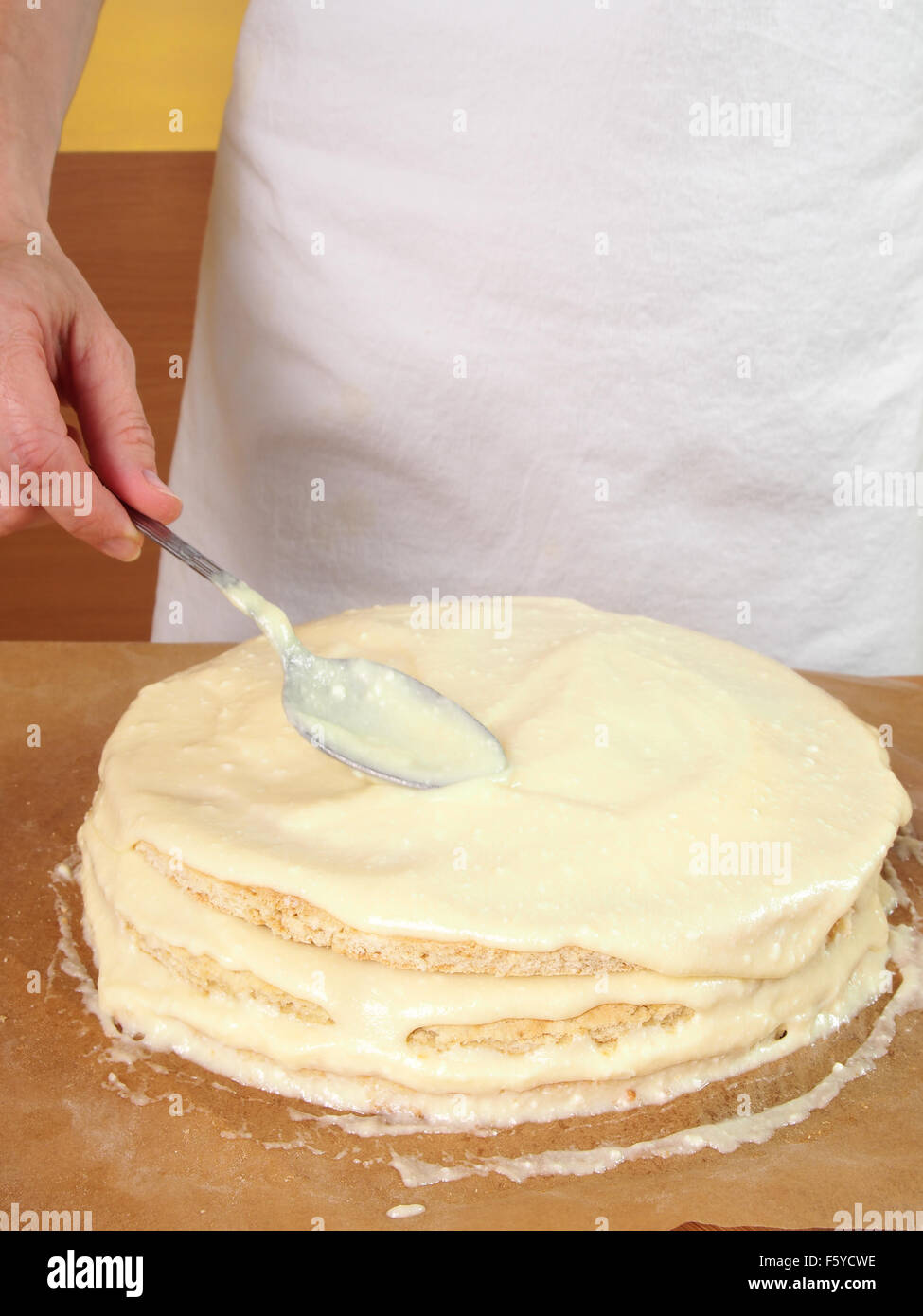 Filling cake layers. Making Chocolate Layer Cake with Cream Cheese ...