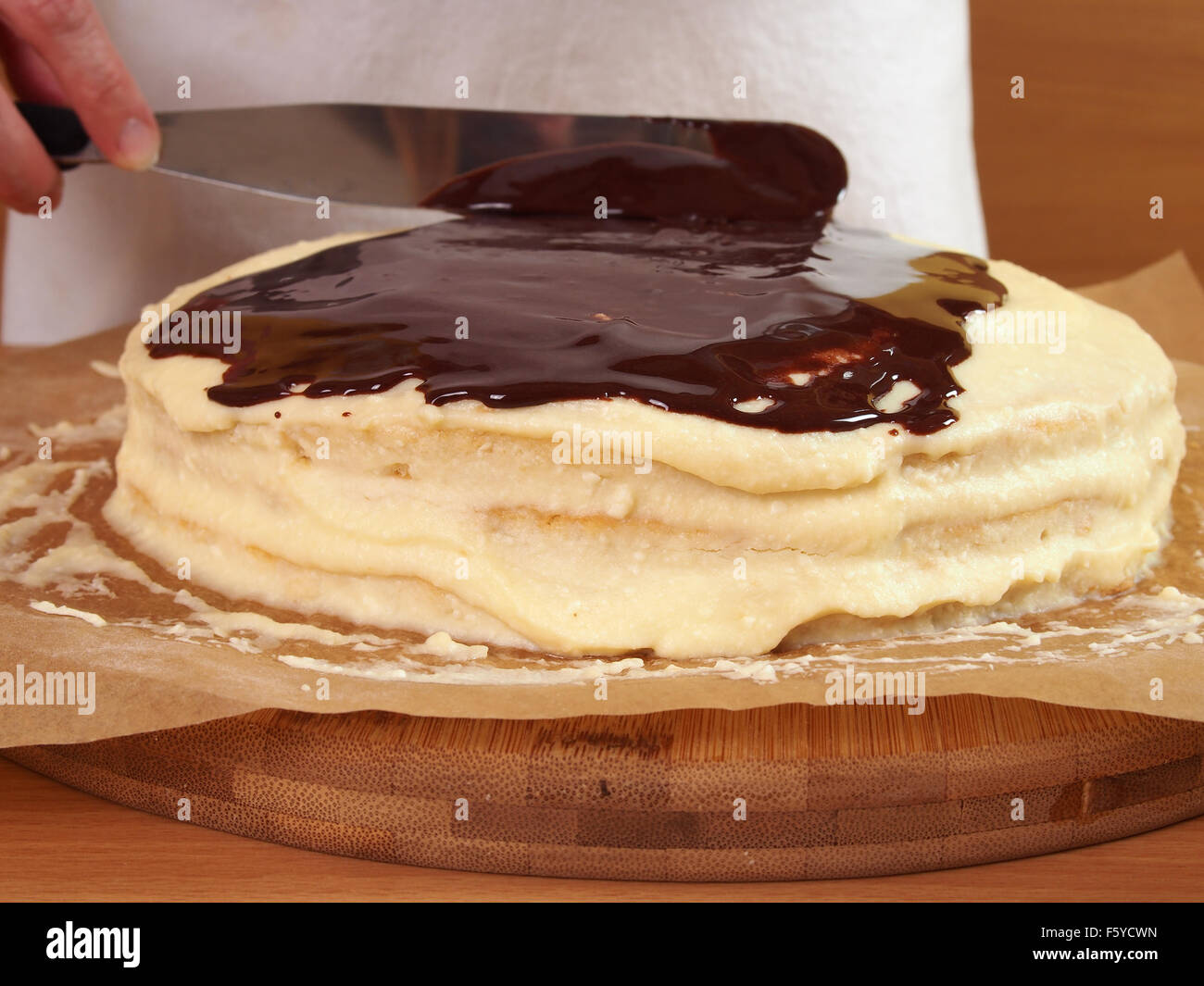 Frosting and icing layers. Making Chocolate Layer Cake with Cream ...
