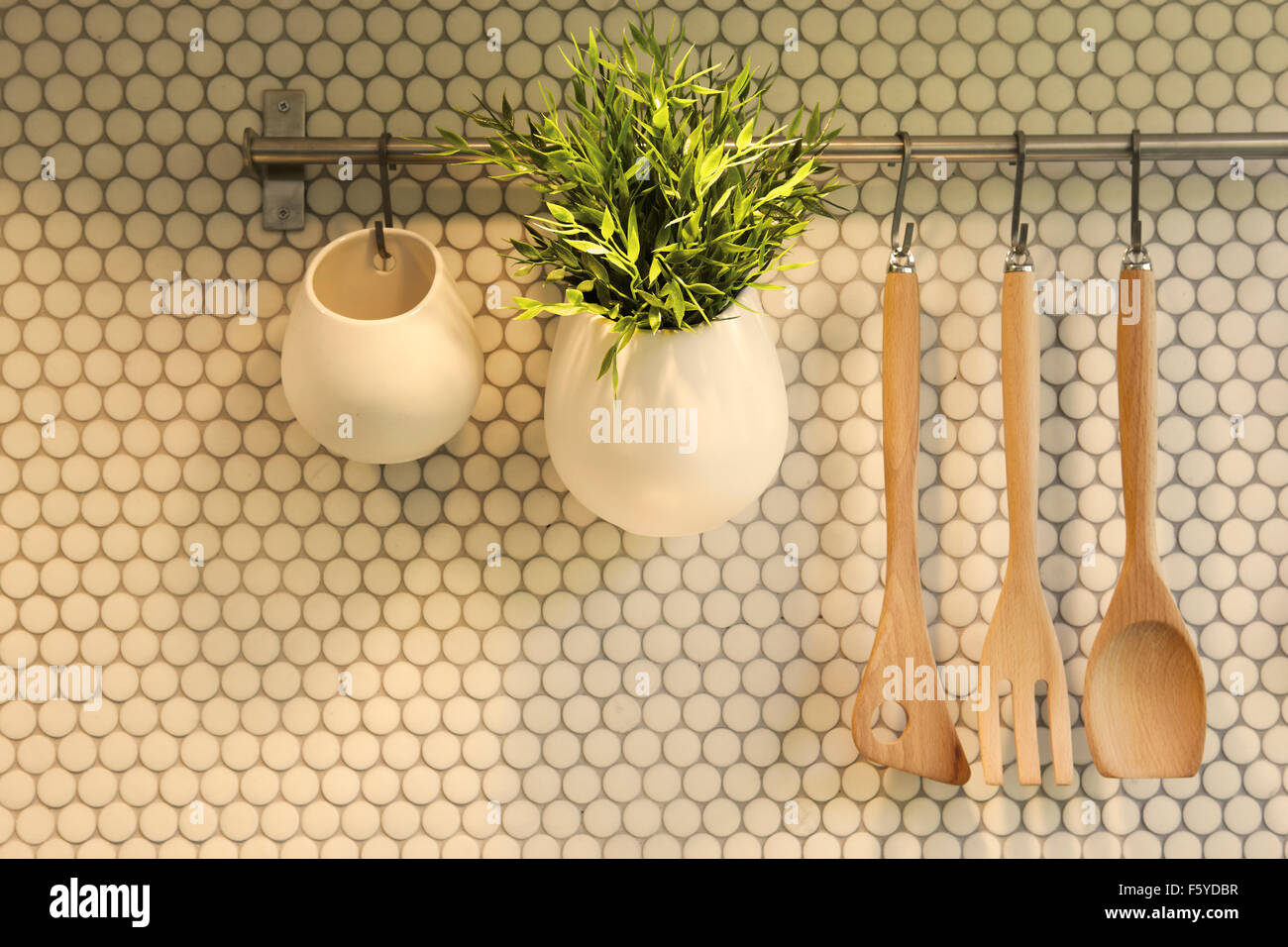 Set of kitchen utensils hanging on wall Stock Photo - Alamy