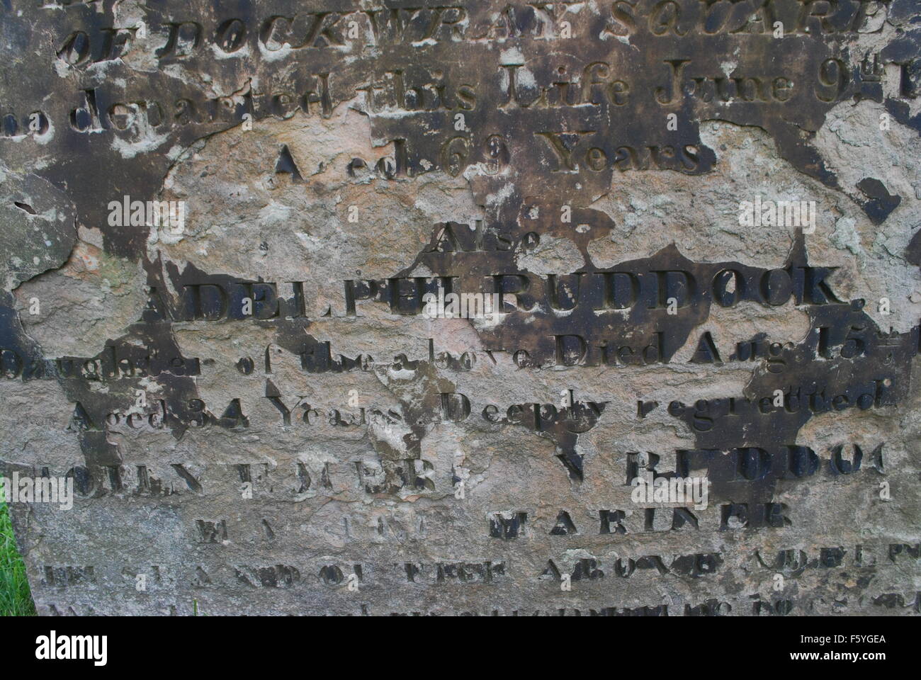 Illegible text on an old gravestone Stock Photo - Alamy