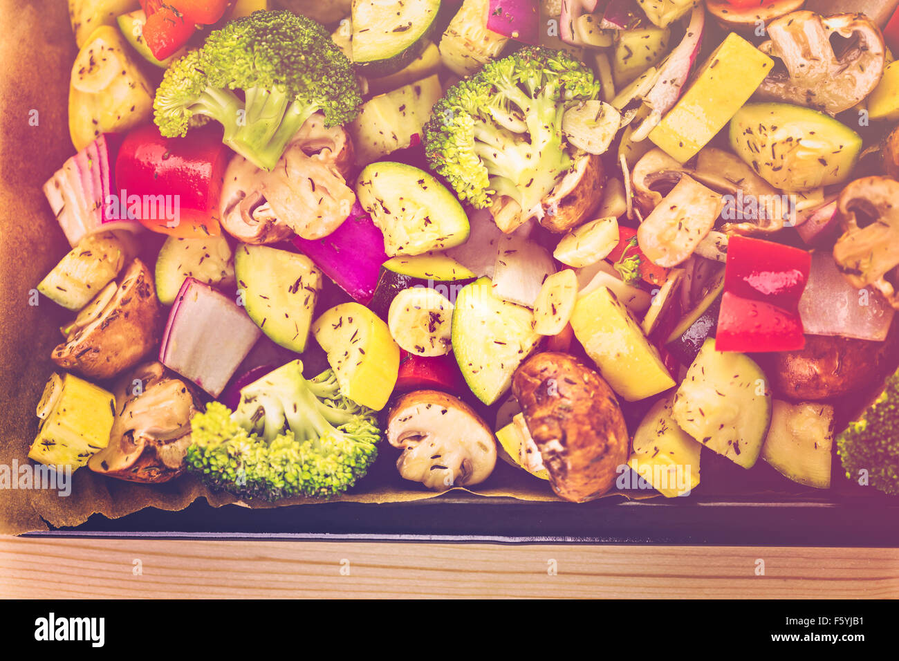 Preparing fresh roasted mixed vegetables for dinner Stock Photo - Alamy