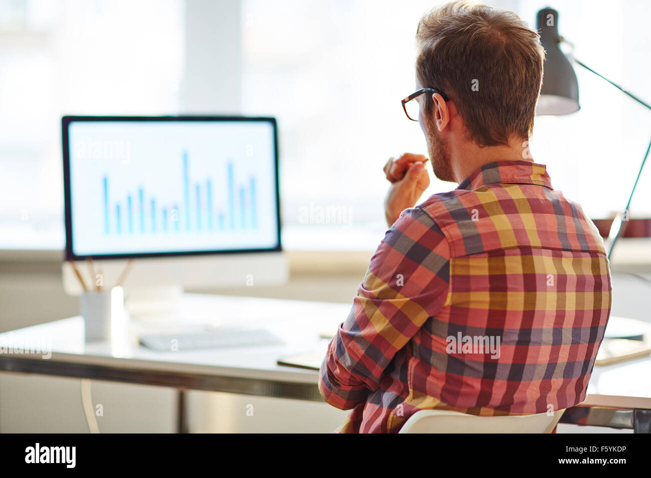 Businessman sitting at the table and thinking about project Stock Photo ...