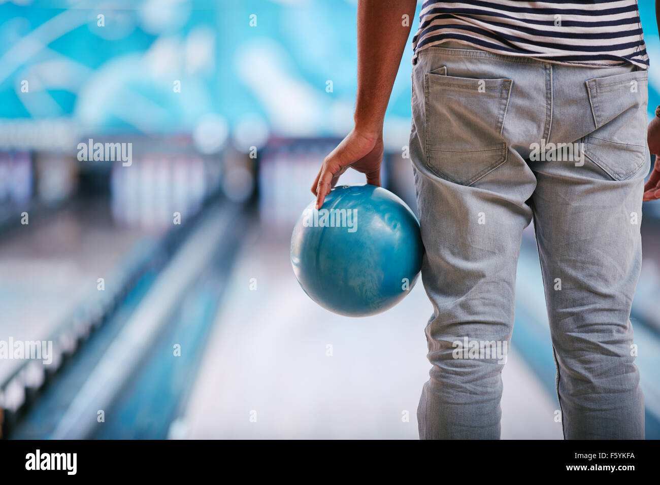 Close-up of man holding a bowling ball Stock Photo - Alamy