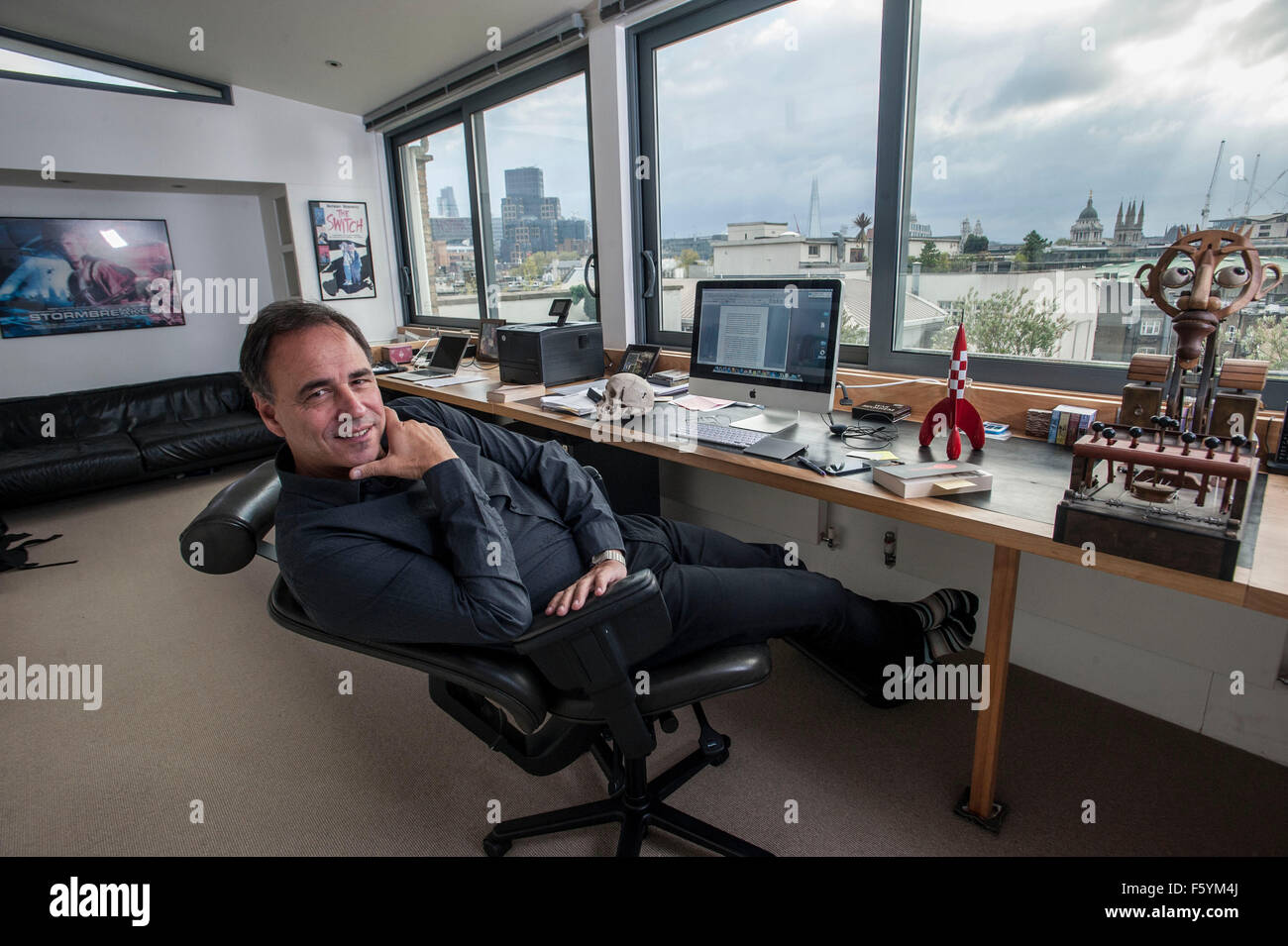 Writer Anthony Horowitz at desk in his home office Stock Photo - Alamy