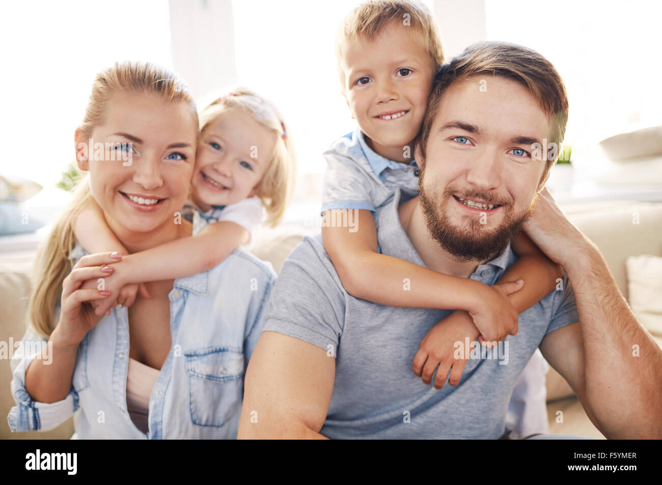 Happy and affectionate kids embracing their mother and father Stock ...