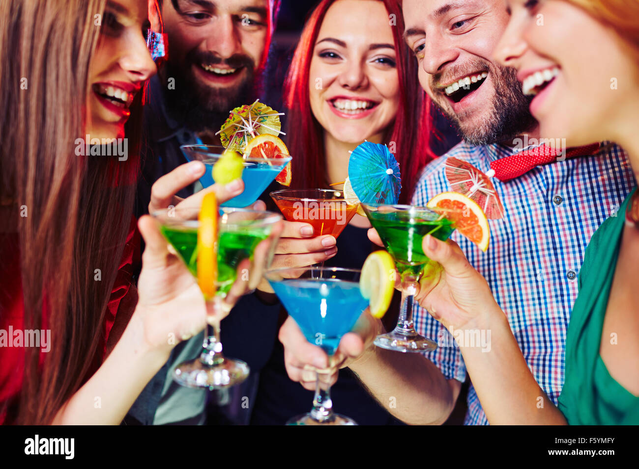 Cheerful friends toasting with cocktails Stock Photo - Alamy