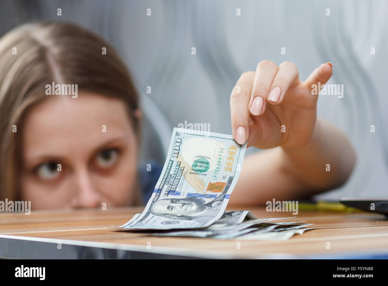 Young happy woman count dollars on the table Stock Photo - Alamy