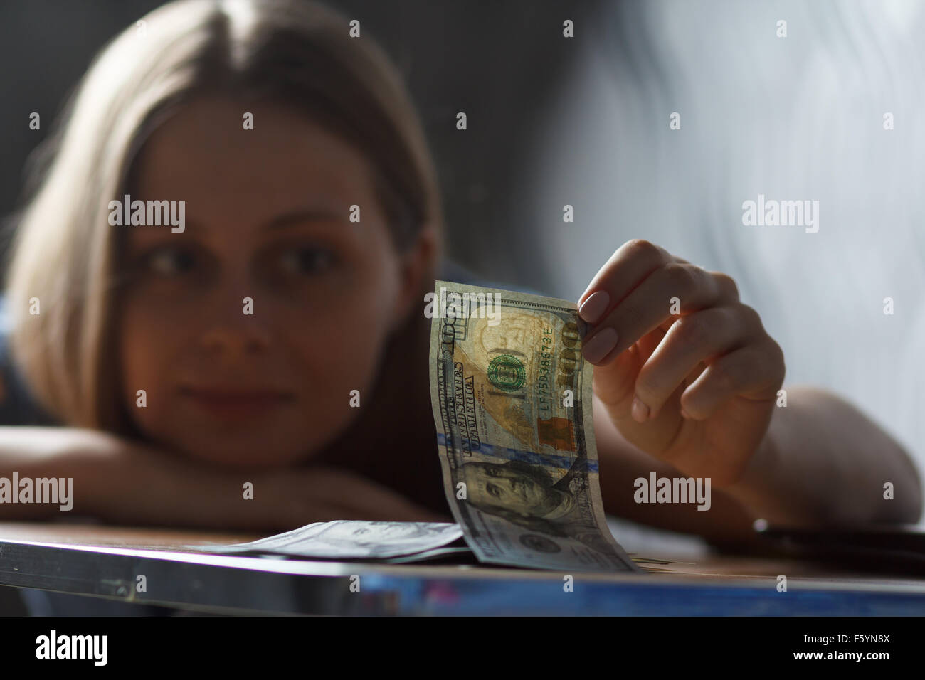 Young happy woman count dollars on the table Stock Photo - Alamy