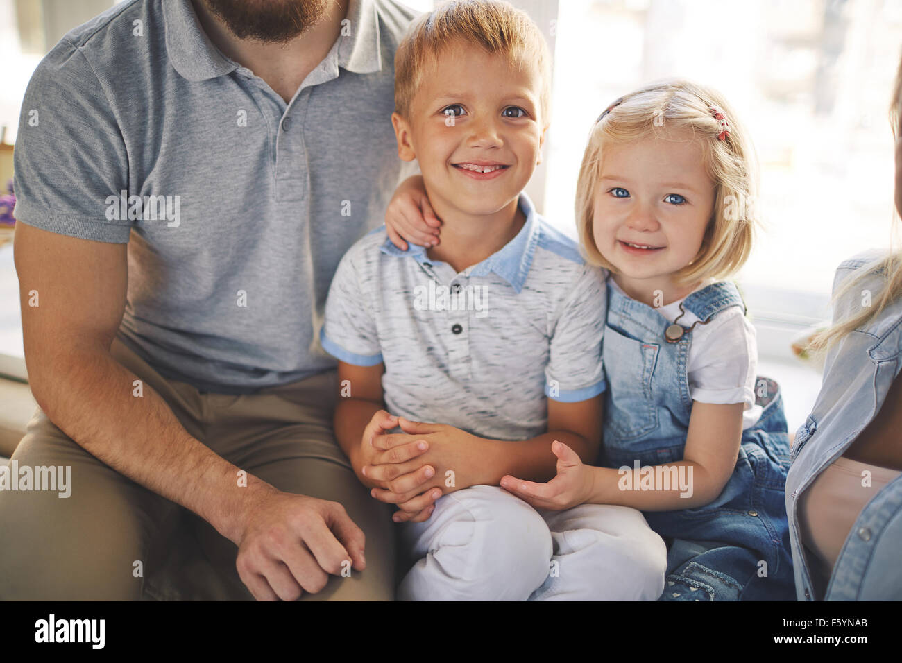 Adorable siblings looking at camera with smiles Stock Photo - Alamy