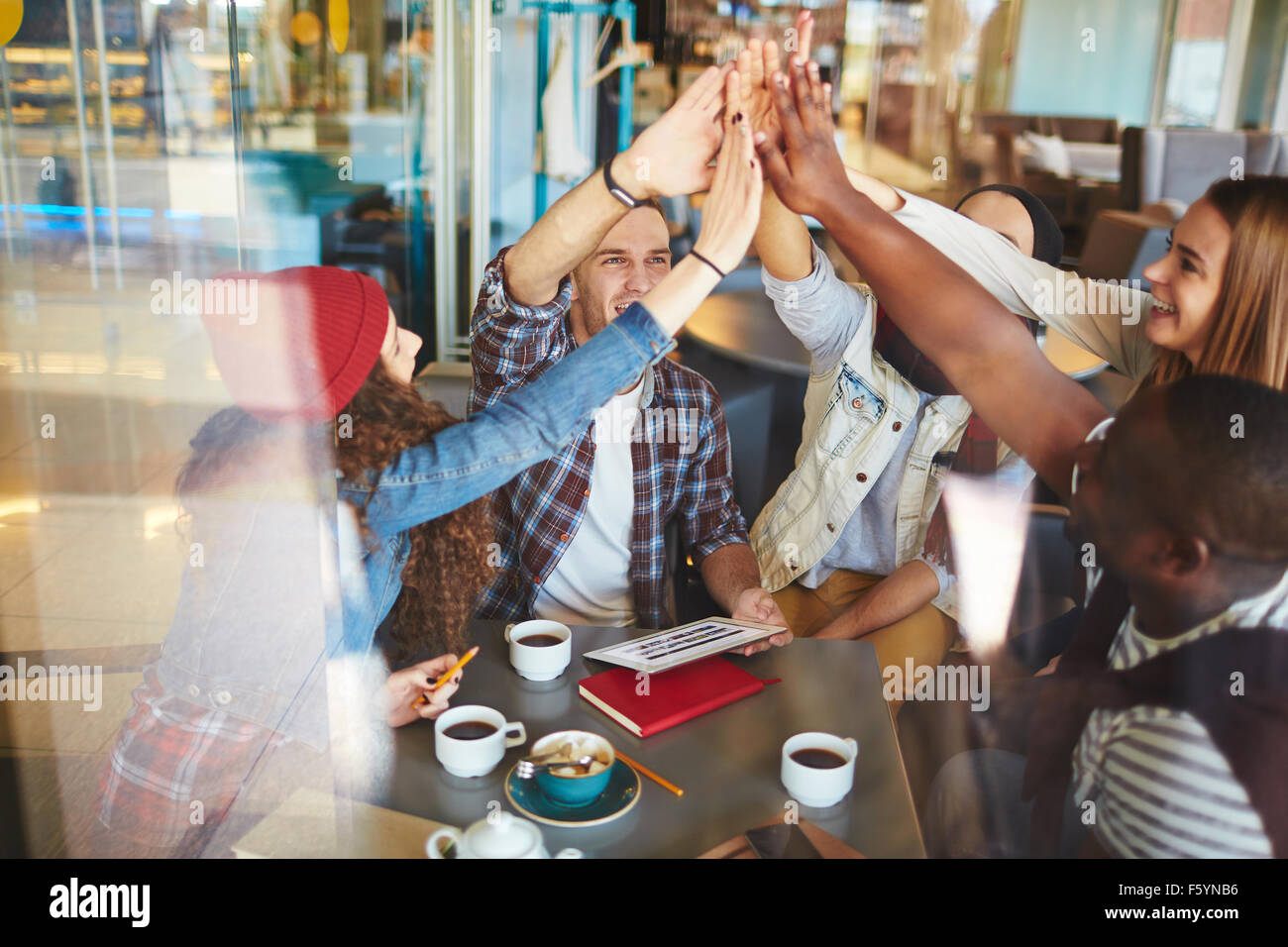 Happy friends touching by their palms Stock Photo - Alamy