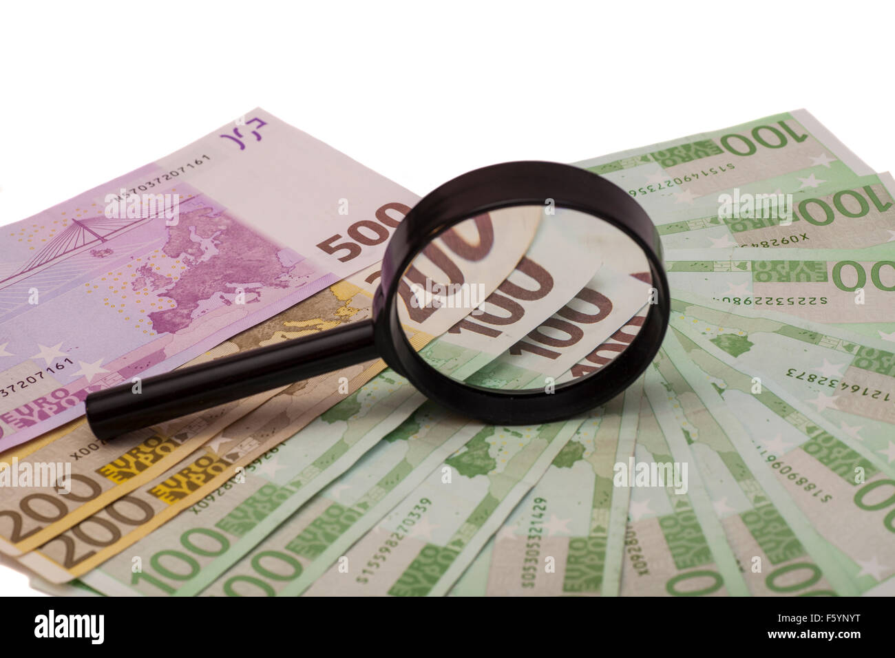 Euro banknote under magnifying glass on white Stock Photo - Alamy