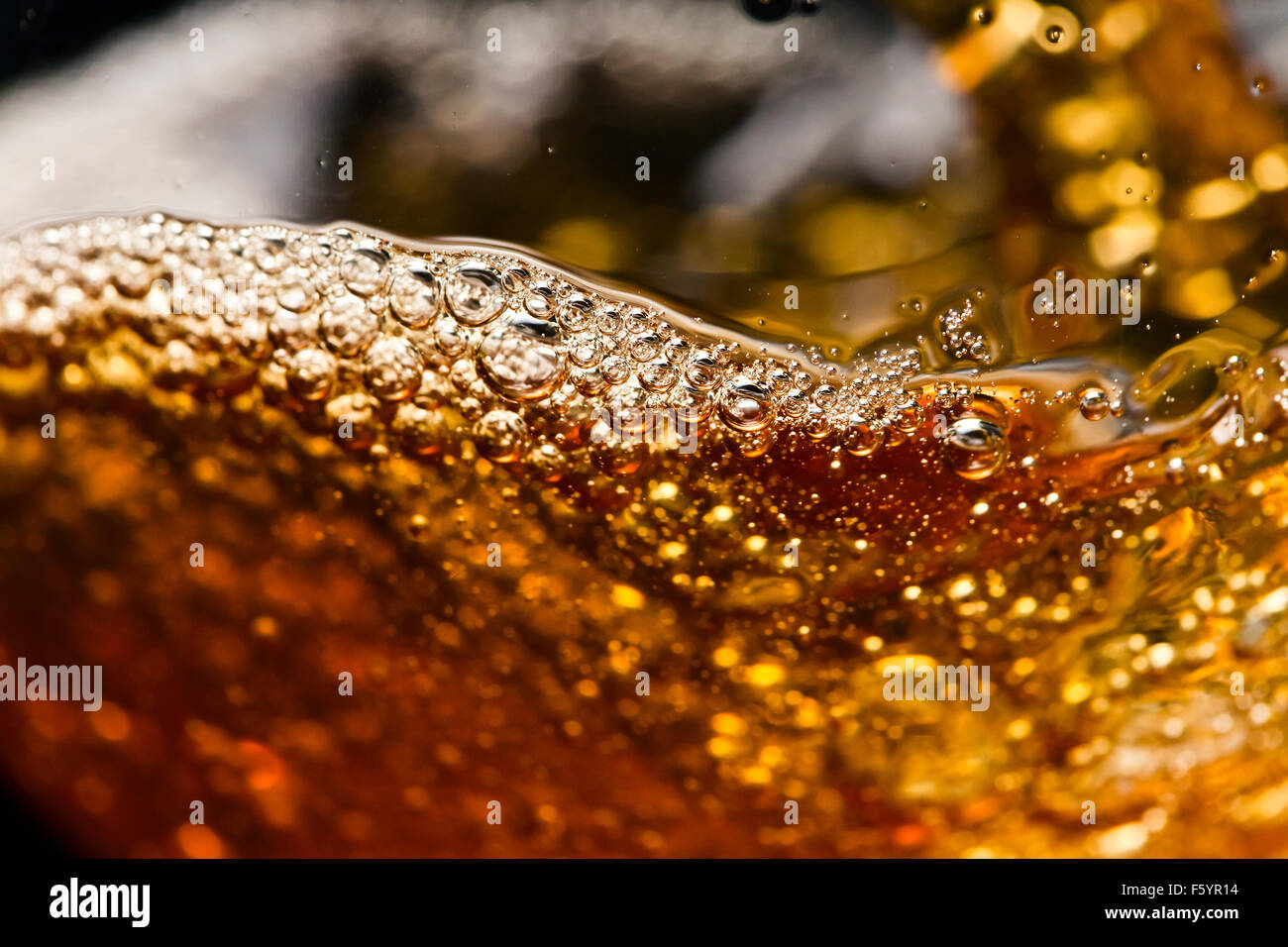 detail of an alcoholic drink on black background Stock Photo - Alamy