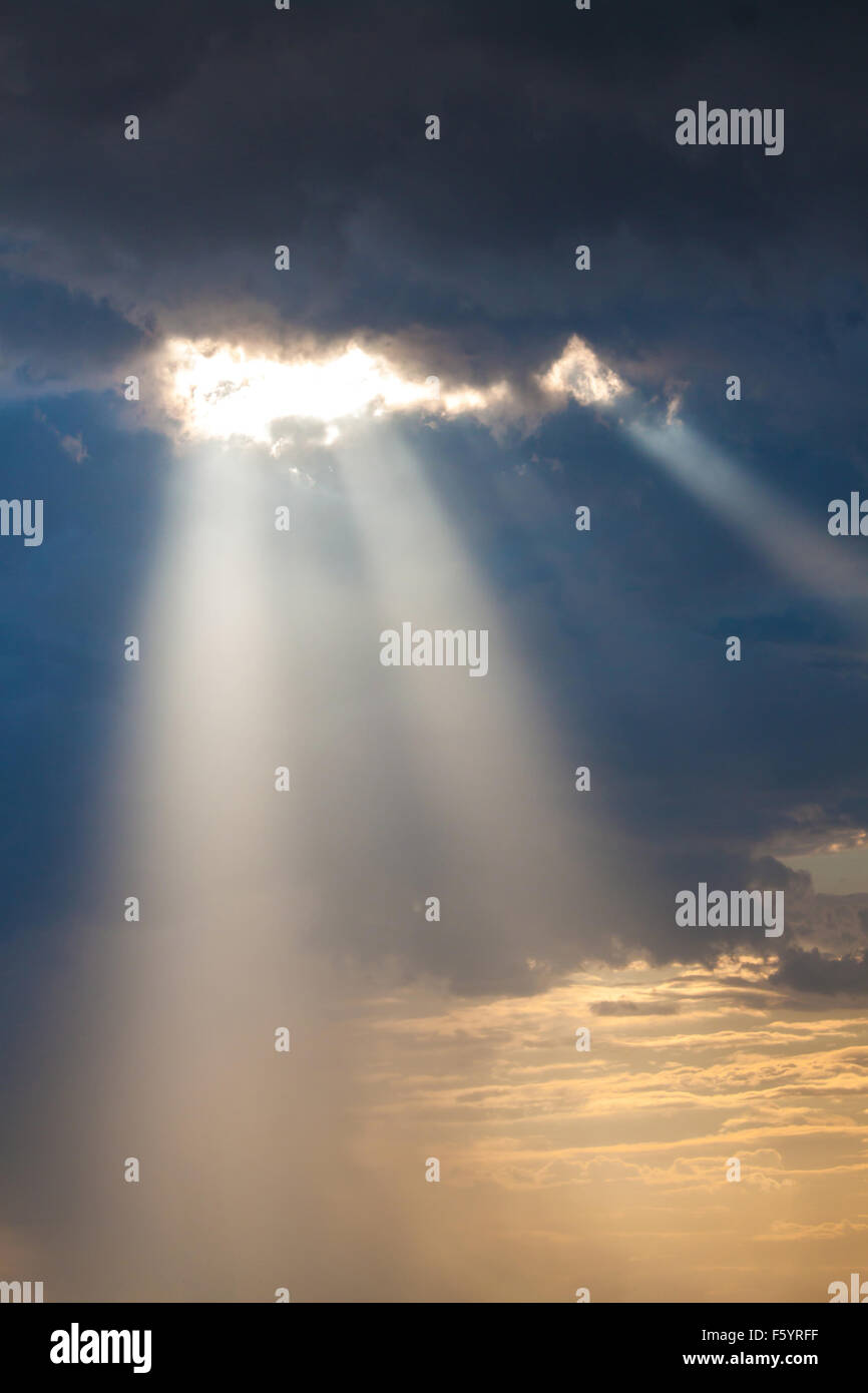 sun ray light through down from rain cloud during sunset time Stock ...