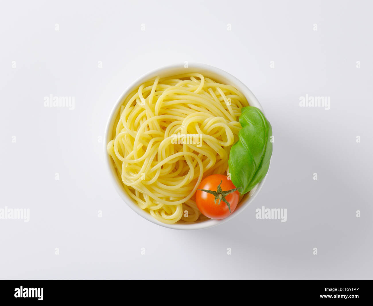 bowl of cooked spaghetti on white background Stock Photo - Alamy