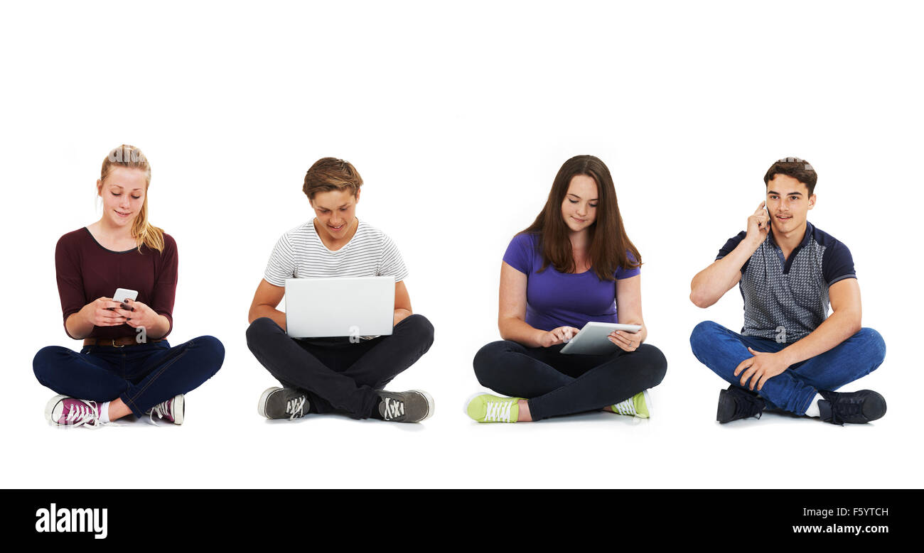 Studio Shot Of Teenagers Using Communication Technology Stock Photo - Alamy