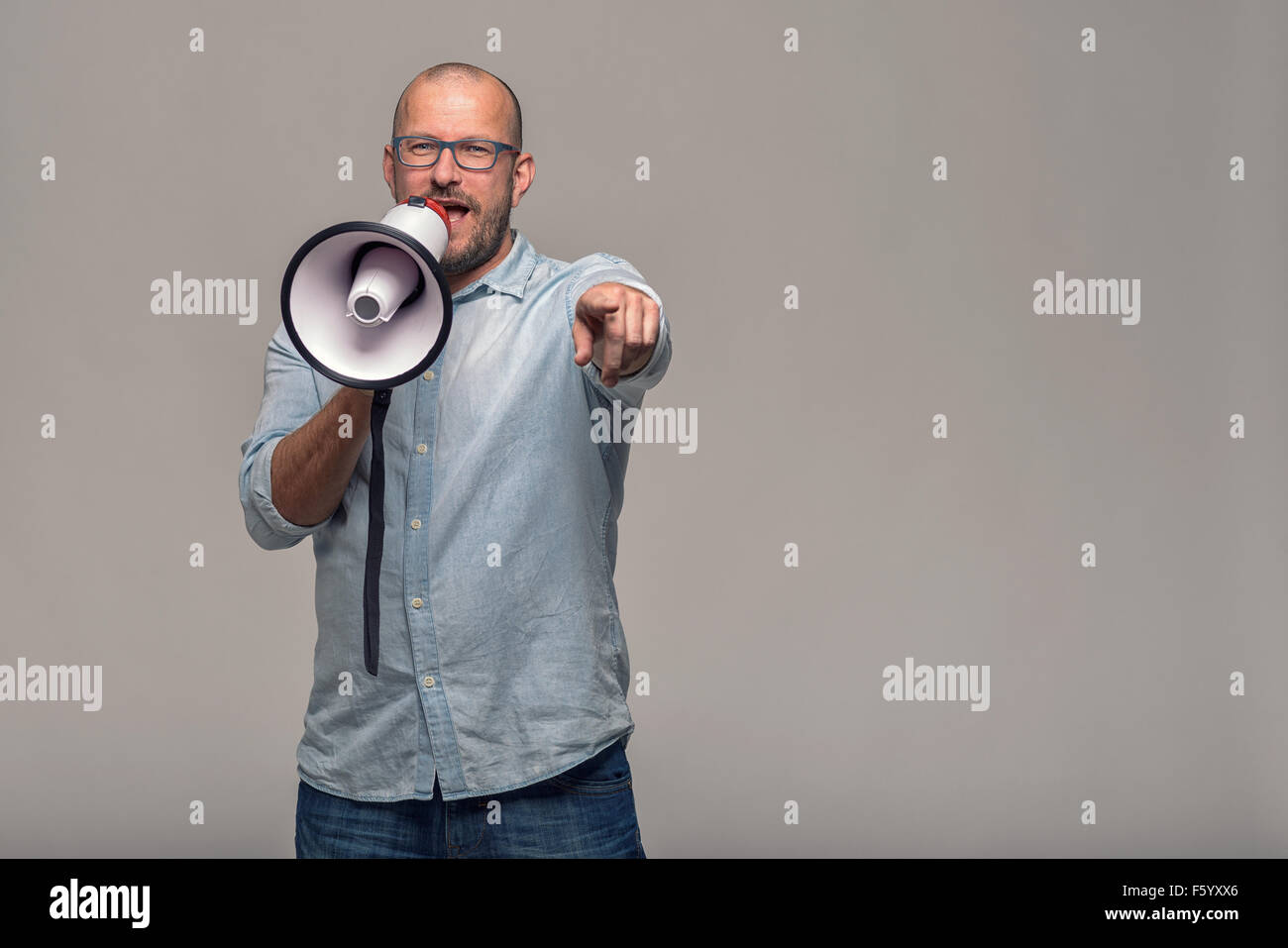 Man speaking over a megaphone as he makes a public address ...